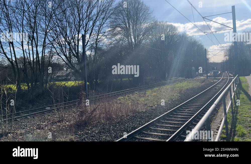 Empty railway tracks with a small piece of green, gray railings in the ...