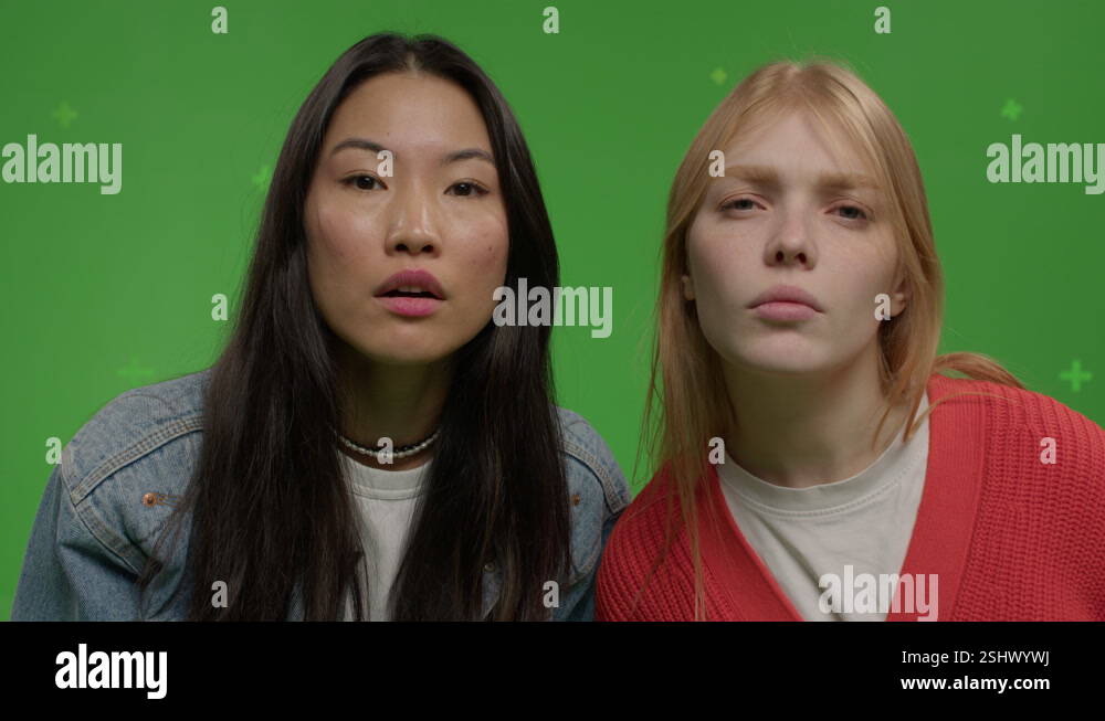 GREEN SCREEN CHROMA KEY Portrait of two girls looking with interest ...