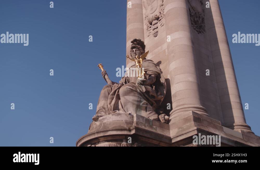 Static view of a stone statue seated on a throne with gold objects in ...