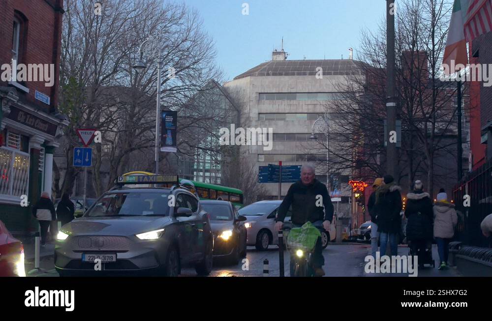 Traffic jam in Dublin with a senior man riding a bike shot handheld ...