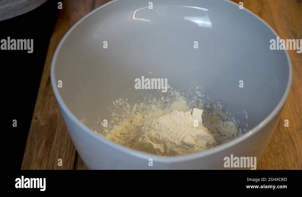 Woman Adding a Spoon of Flour to a Bowl Stock Video Footage - Alamy