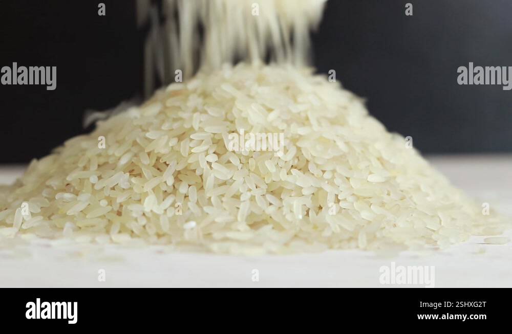 Rice grains spill out of a plastic white scoop, close-up Stock Video ...