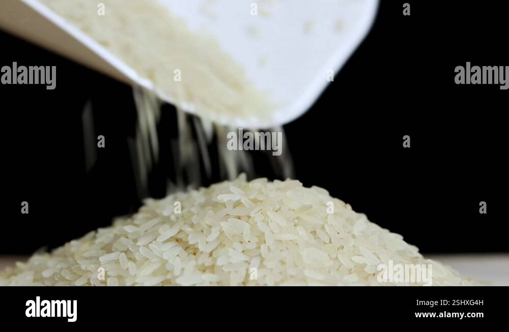 Rice grains spill out of a plastic white scoop Stock Video Footage - Alamy