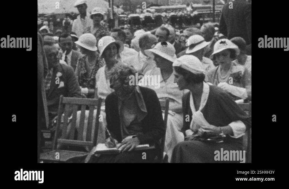 1930s: Amelia Earhart sits in a chair writing in a book. She talks to ...