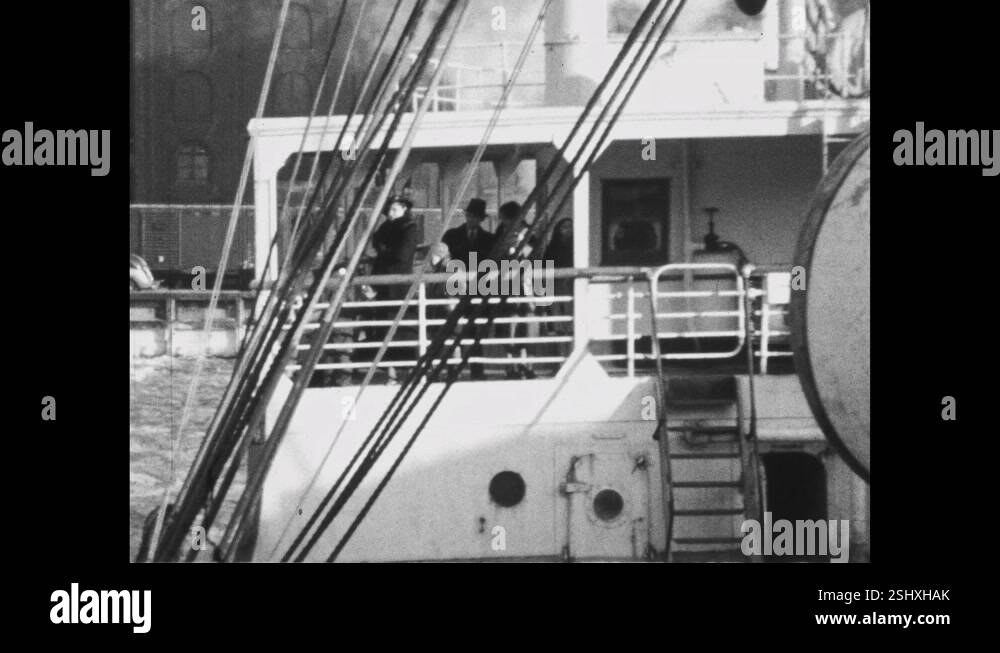 1930s: Crew on ship deck. Crew closing doors. People on ship, pan to ...