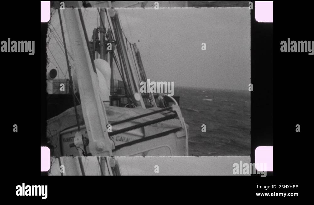 1930s: Tracking shots of ocean, front of ship. Man smoking on ship deck ...