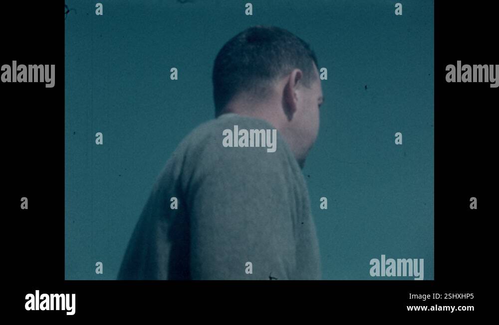 1950s: Fishing boat out on open water. Rod fishing off back of boat ...