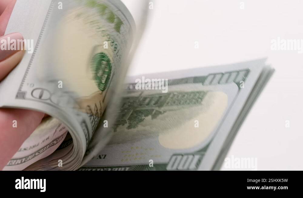 hand counts while flipping through a stack of one hundred dollar bills ...