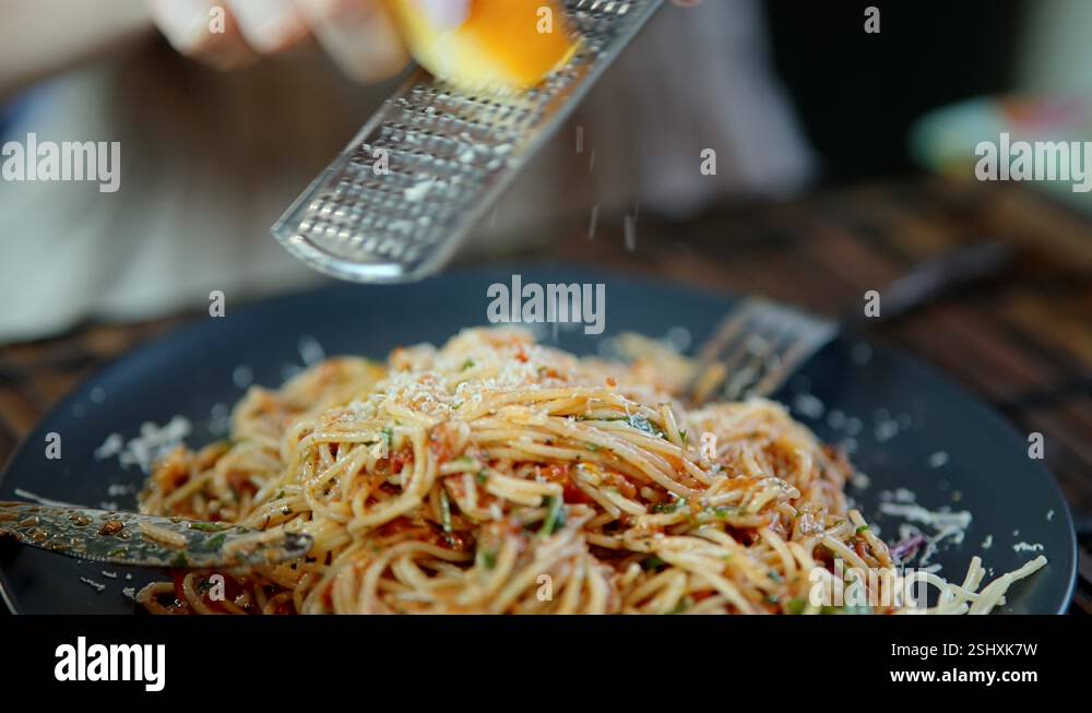 Grating Pecorino Cheese On Spaghetti In Plate. Cook Grated Cheese To ...