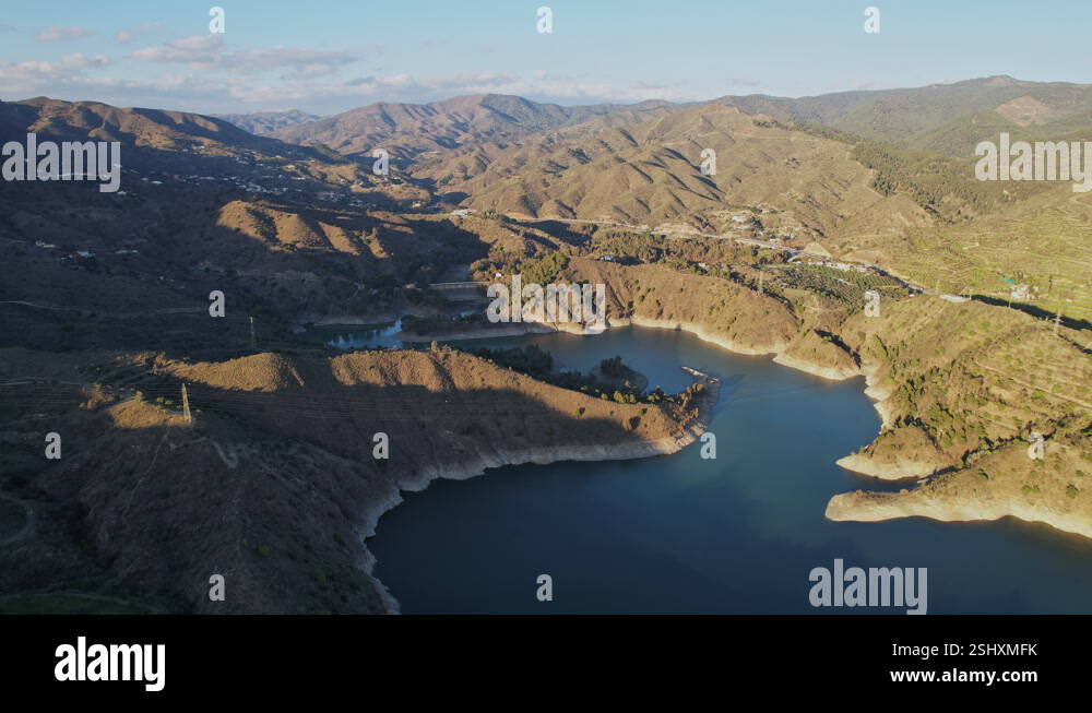Embankment dam in south of Spain with a blue sky and clouds in city of ...