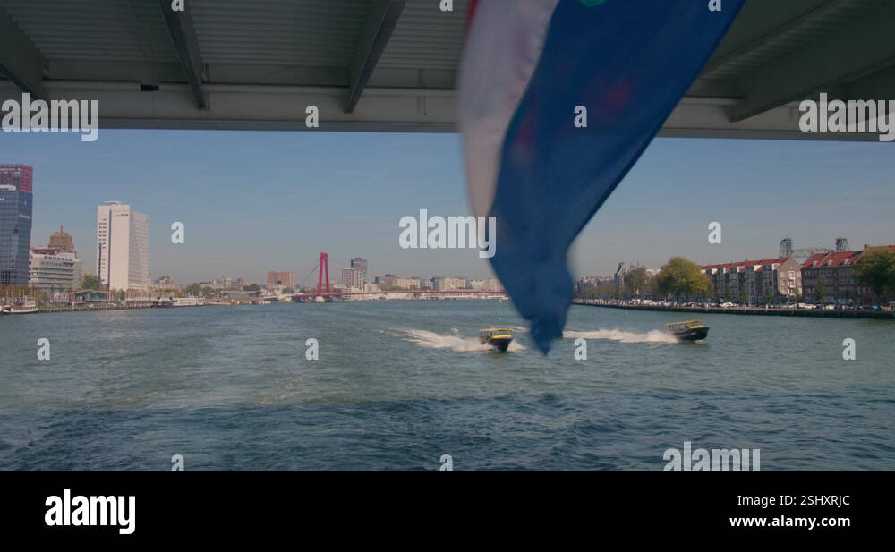 Onboard a cruising ship, sailing under a bridge. Two motorboats ...