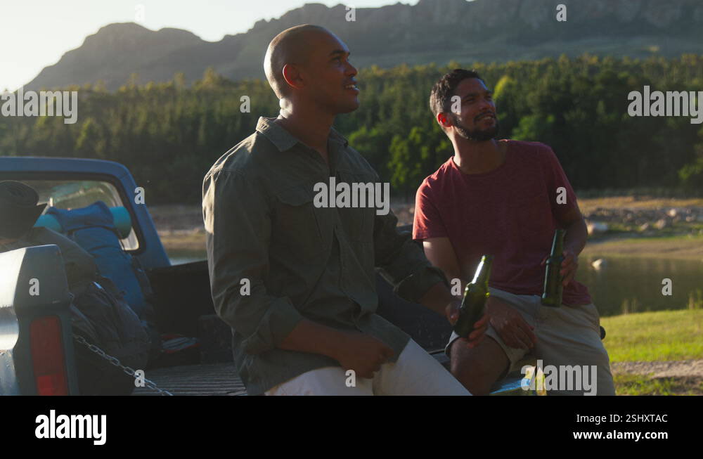 Two Male Friends With Backpacks In Pick Up Truck On Road Trip By Lake ...