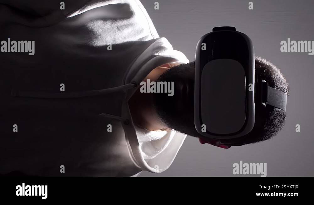 Blue lightning animation overlay over VR goggles worn by man; vertical ...