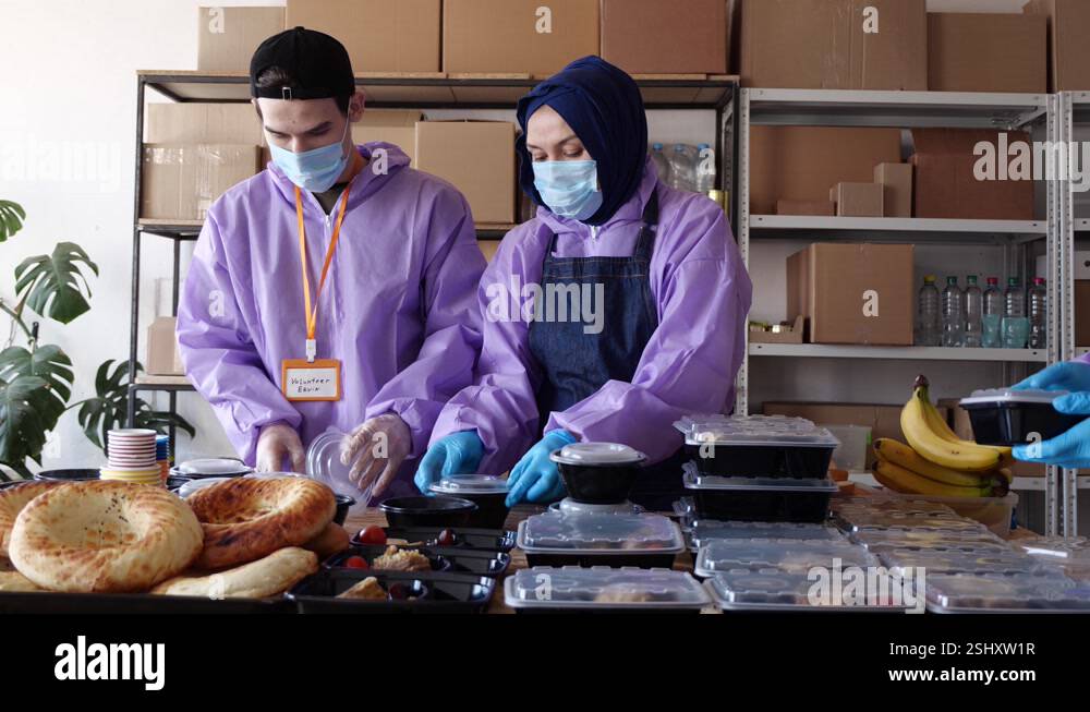 Muslim kitchen volunteers prepare and distribute hot iftar takeaway ...