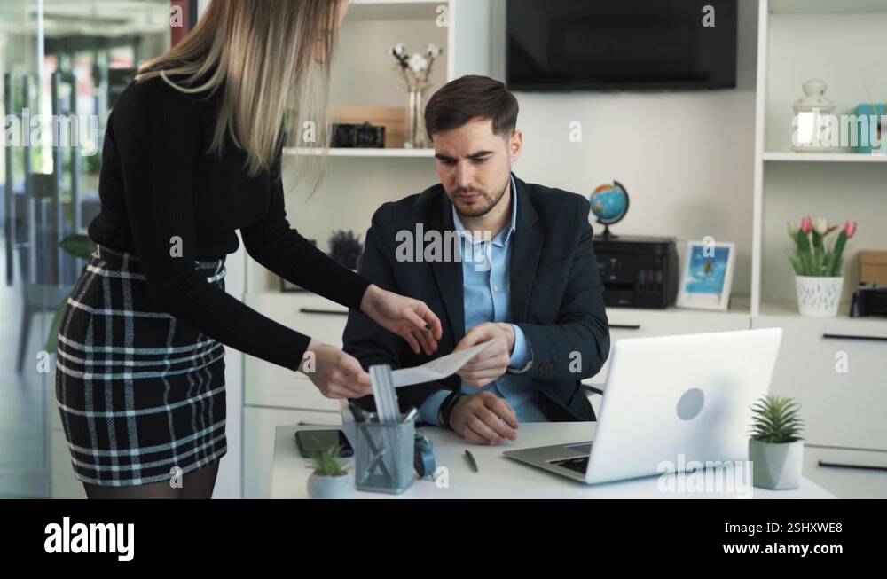 Angry young man, manager scolding his employee in the office for a ...