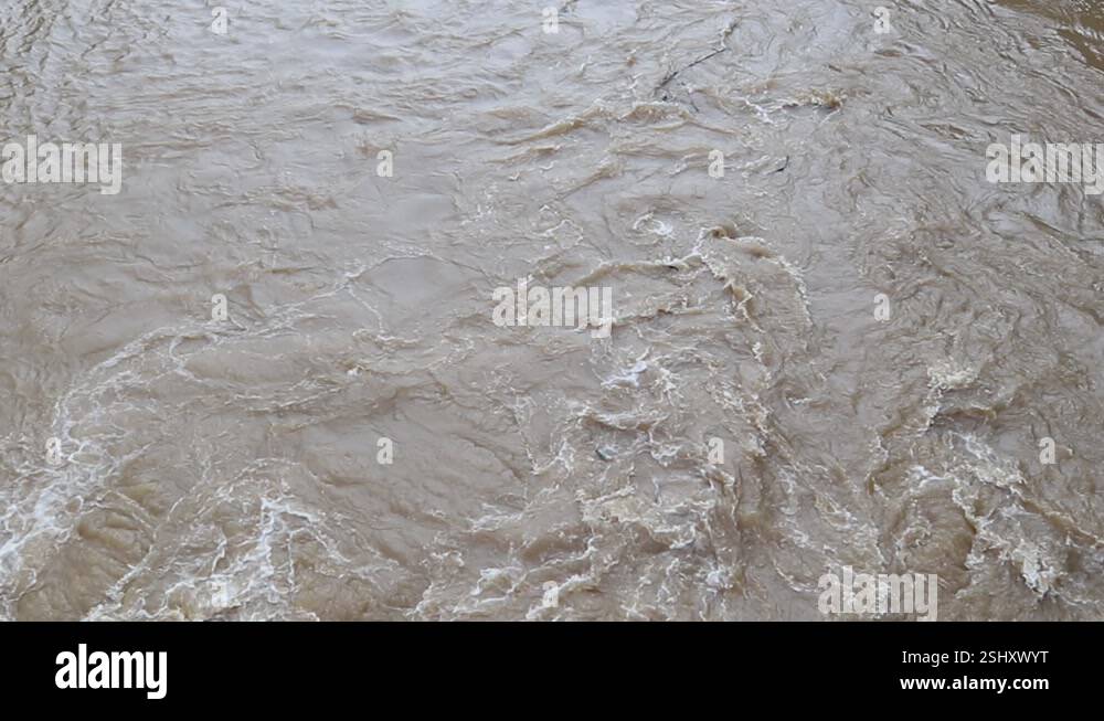 The fast moving muddy foamy water flowing of the Kalu Ganga river Stock ...