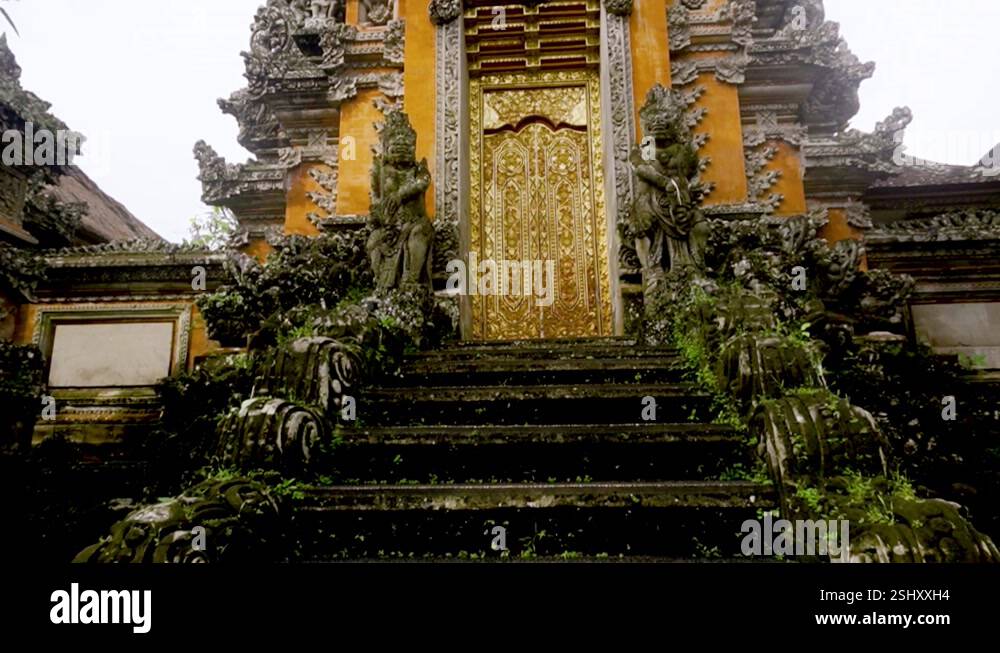 Tilt up reveal of ornate gold Saraswati Temple steps in jungle and ...