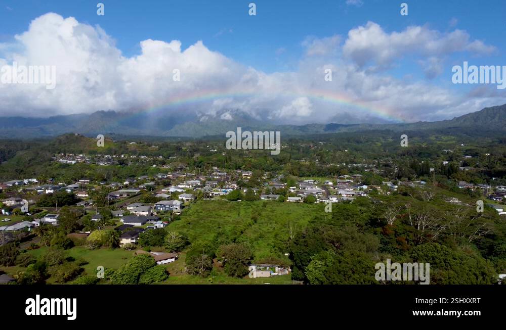 Cinematic arial view of rainbow in cloudy sky in Kauai, Hawaii, USA ...