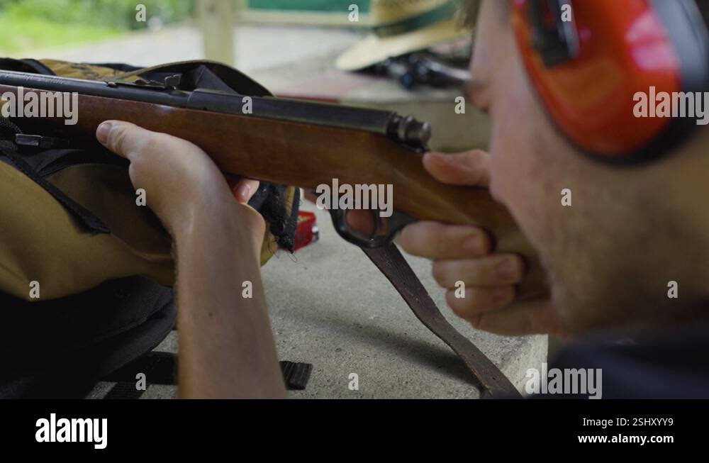 Closeup Of A Man Aiming And Firing Shotgun At Target In Shooting Range ...