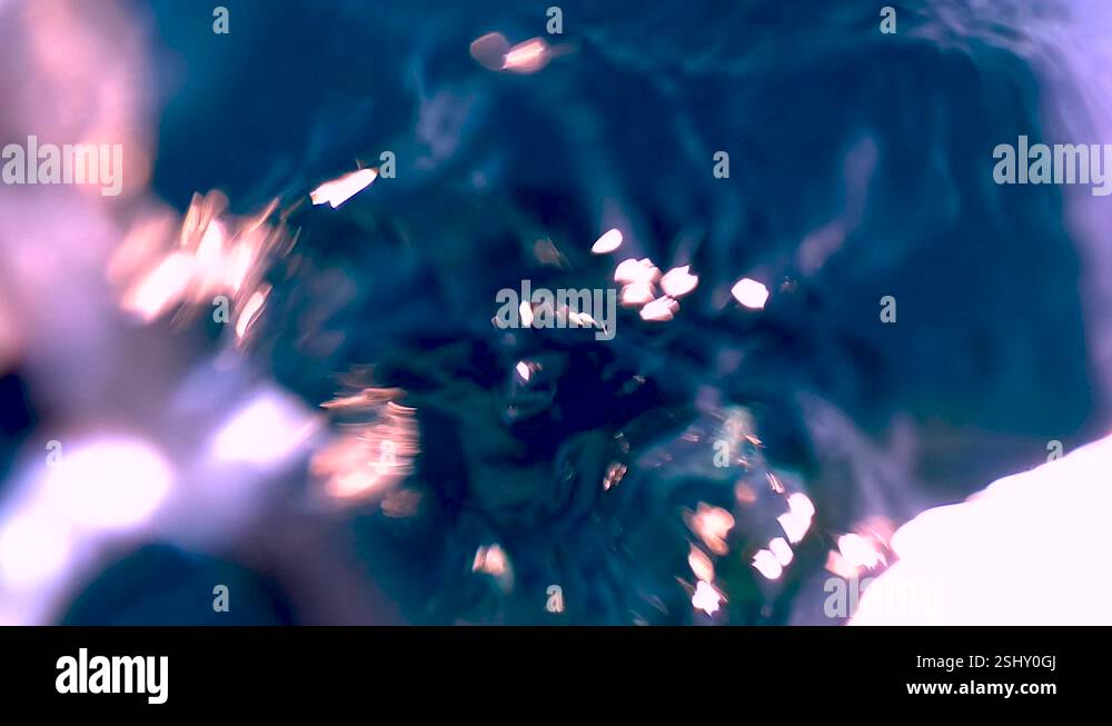 Rising view breaking the surface of deep blue oceanic waters bubbles ...