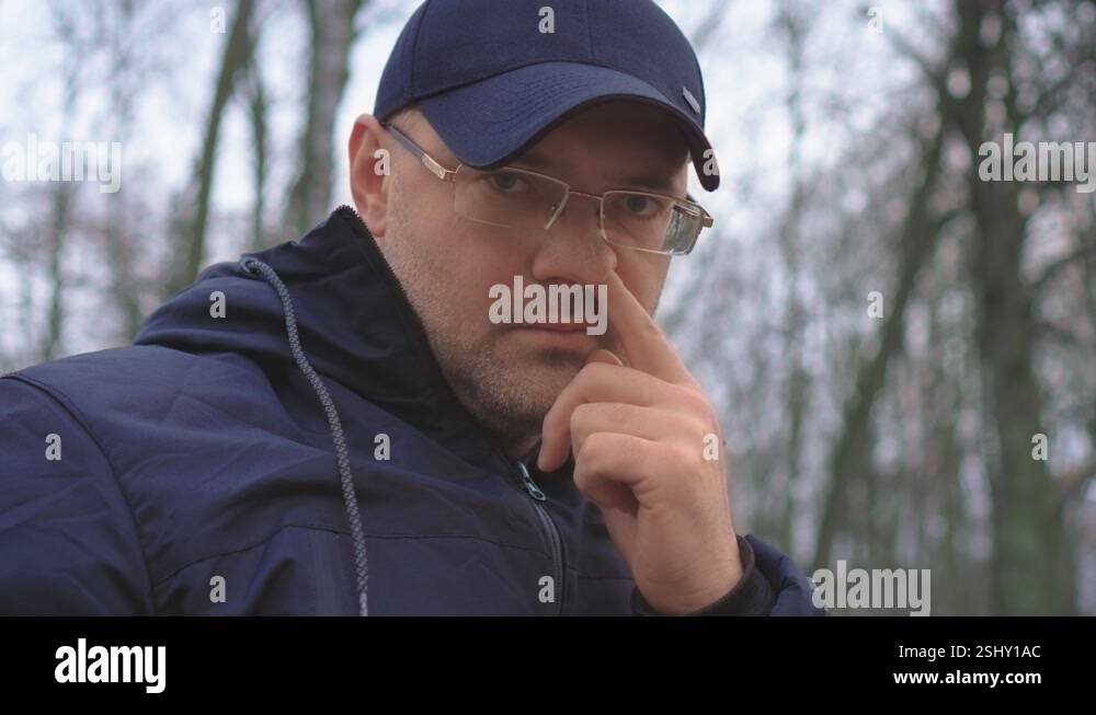 Freak man in park picking his nose, madhouse patient scratches his ...