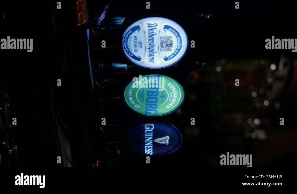 Draught Beer Logos From A Pub Tap. Dark Vertical Shot Of Irish Pub ...