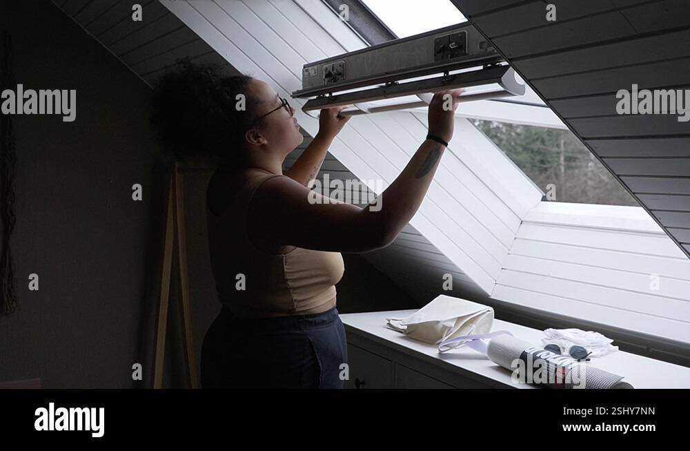 people concept - african american young woman closing window in her ...