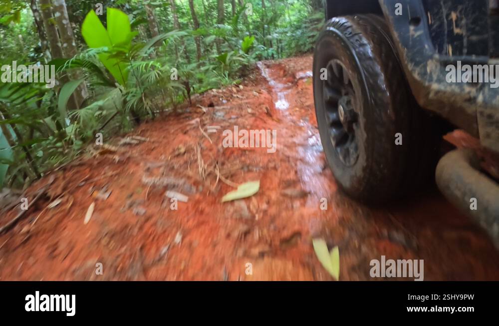 4x4 jeep driving off-road inside muddy and rough soil road inside the ...