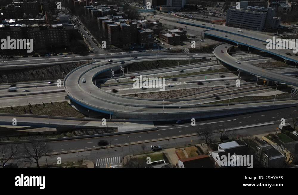 An aerial time lapse high over a busy highway intersection in Queens ...