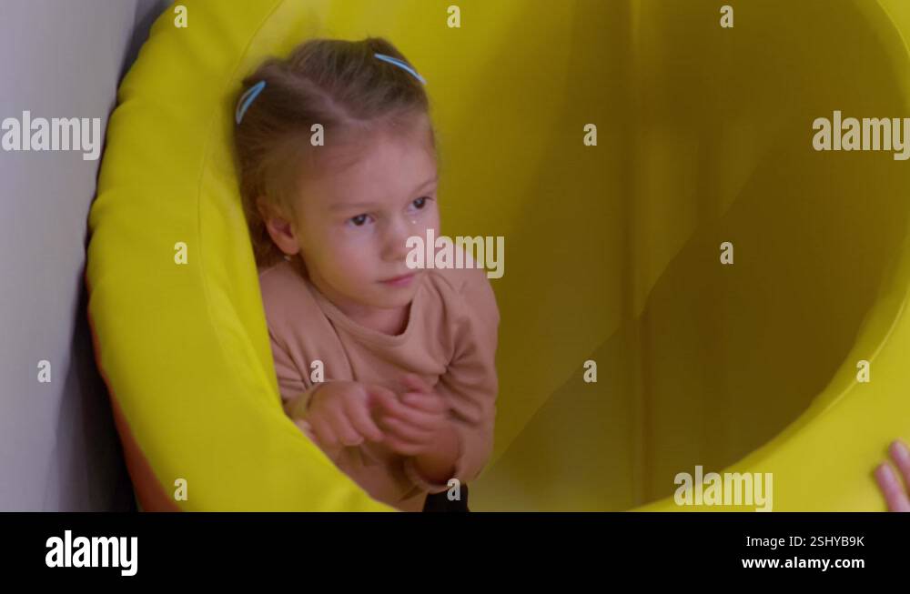 Kid girl rotation in roller tonnel during sensory integration session ...