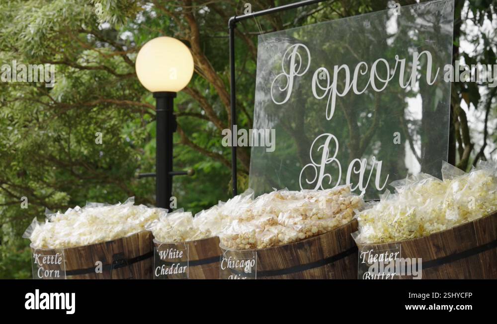 Popcorn bar. Wooden barrels full of popcorn of different flavors ...