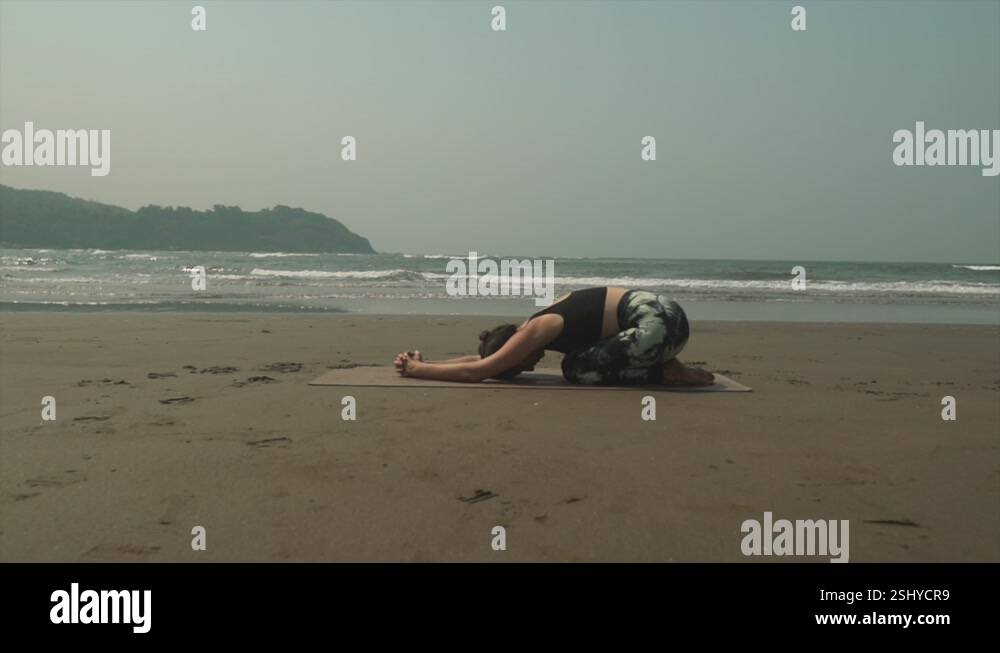 Captured in slow motion, a woman's yoga poses become a graceful ode to ...