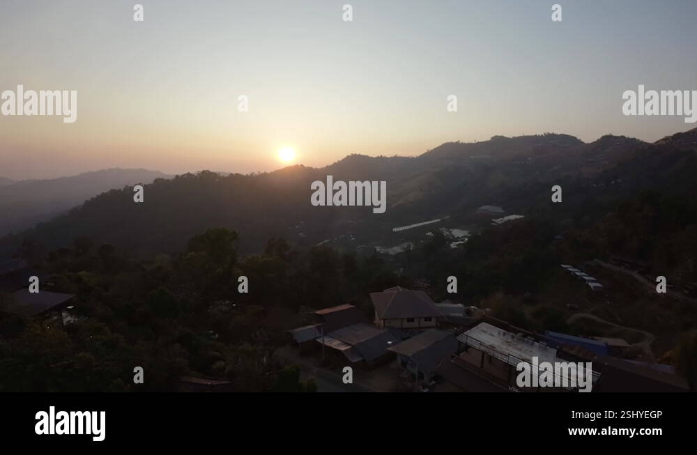 Cinematic FPV shot overhead a residential area during sunset in ...