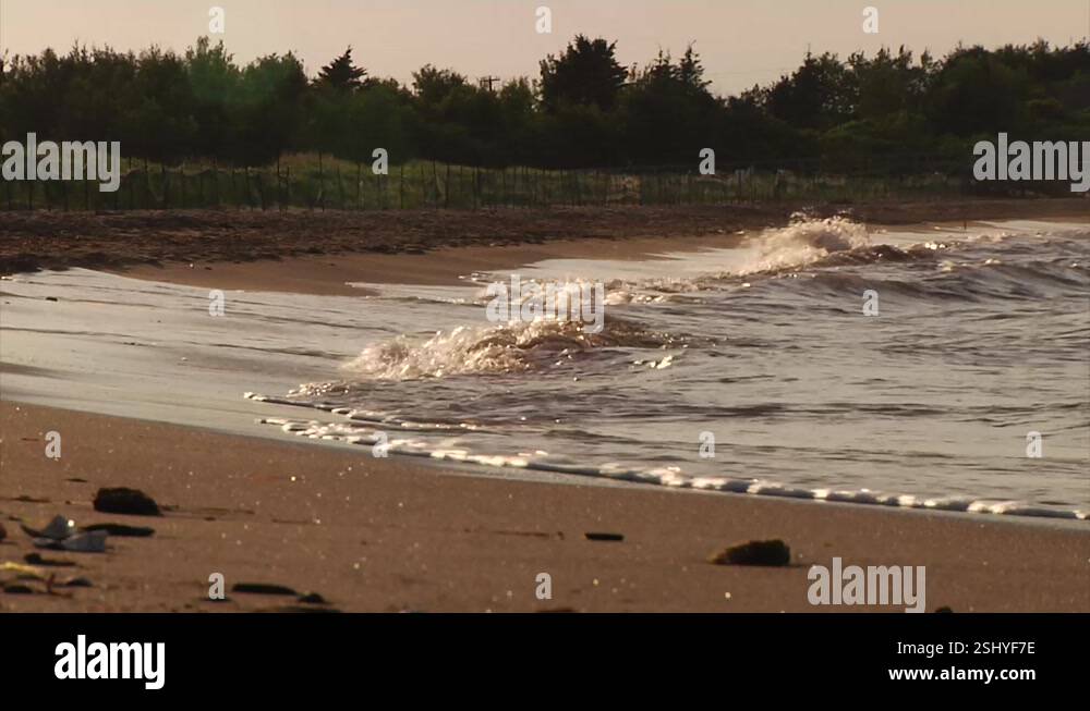 Beach waves and crashing surf on the Bouctouche Beach as the tide comes ...