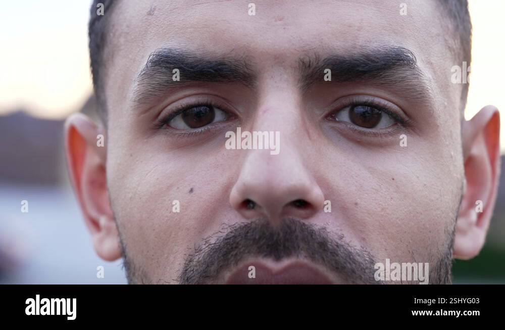 One Middle Eastern man portrait eyes looking at camera with serious ...