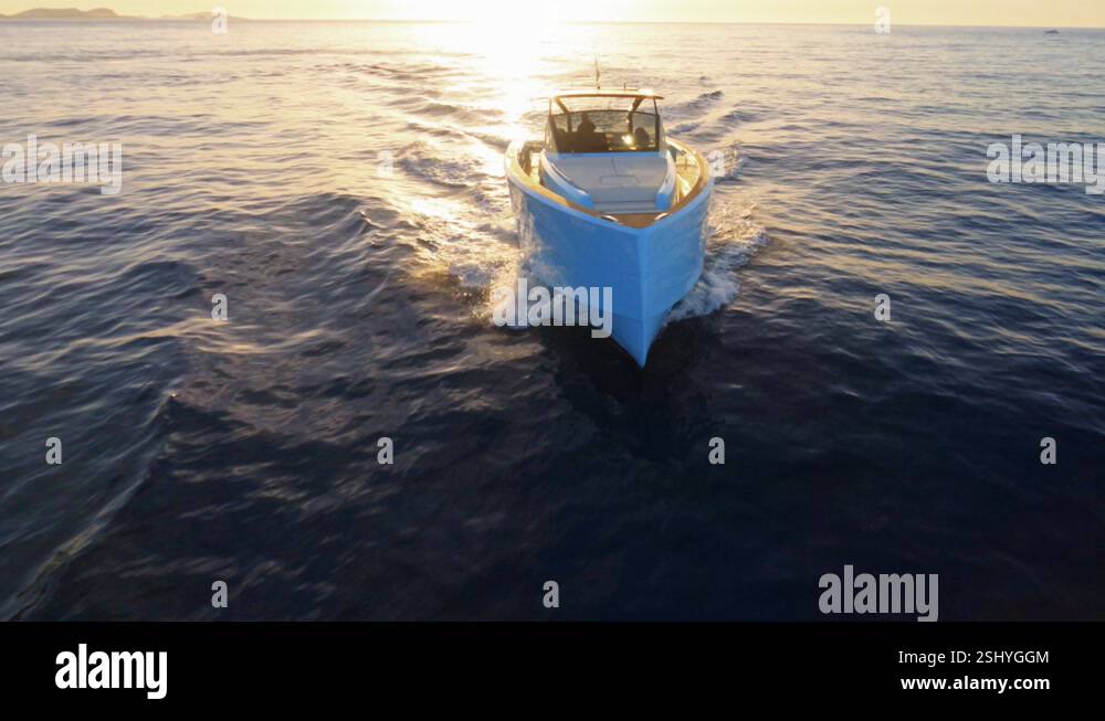 Scenic FPV aerial circling a luxury yacht sailing off the coast of ...