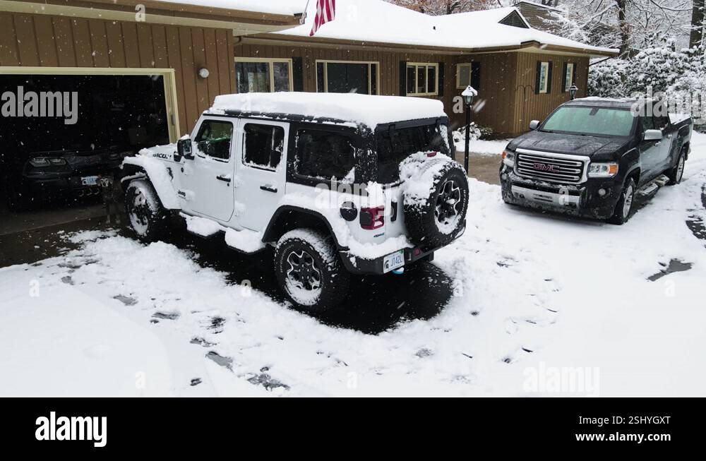 Circling around a vehicle as the owner sweeps snow off of it Stock ...