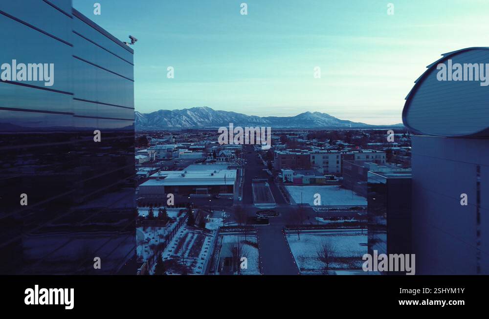 sweep through building tops in provo utah during dusk blue hour with ...