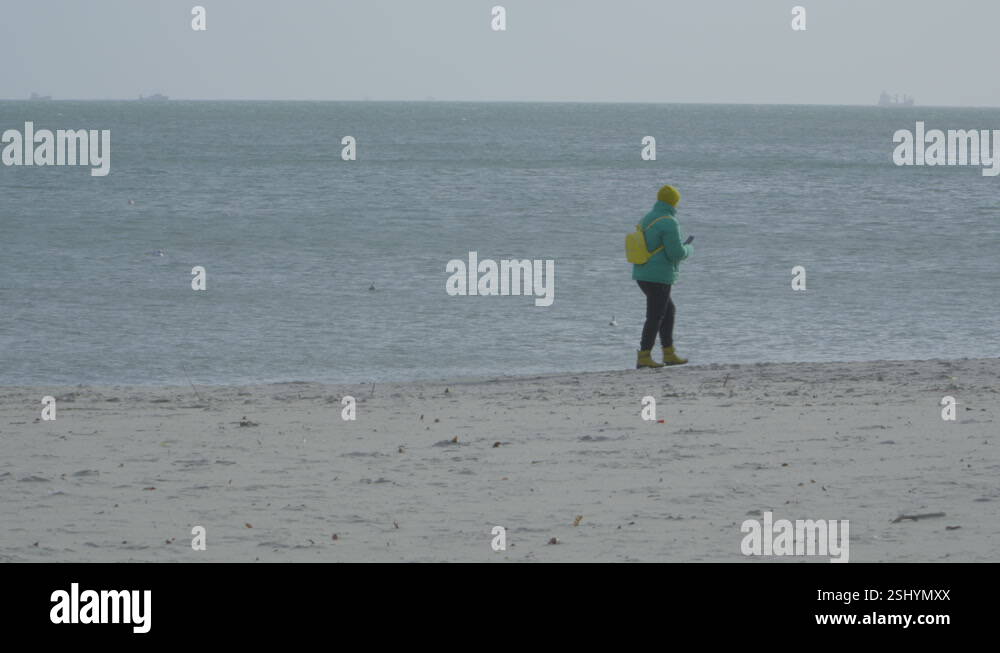 Lone Person Walking Through Peaceful Sandy Foreshore In A Misty Morning ...