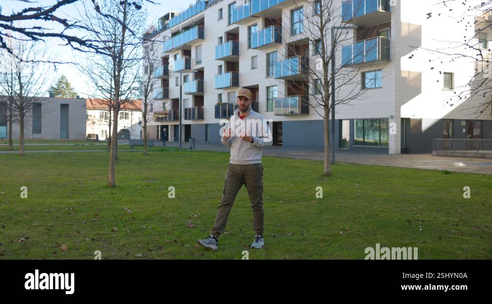 Presenter talking to a camera while walking and getting closer while ...