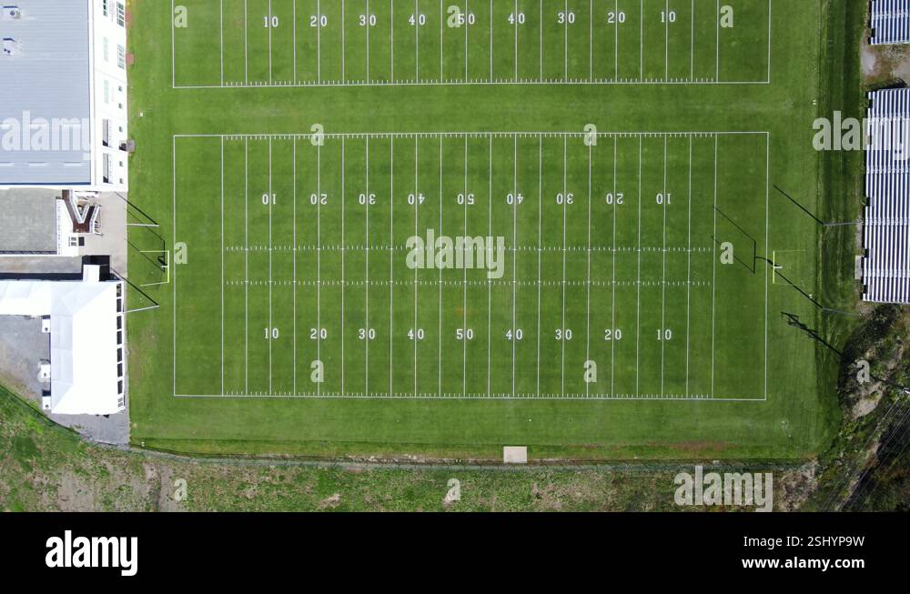 Top-down aerial rise-up shot over football field at The Greenbrier ...