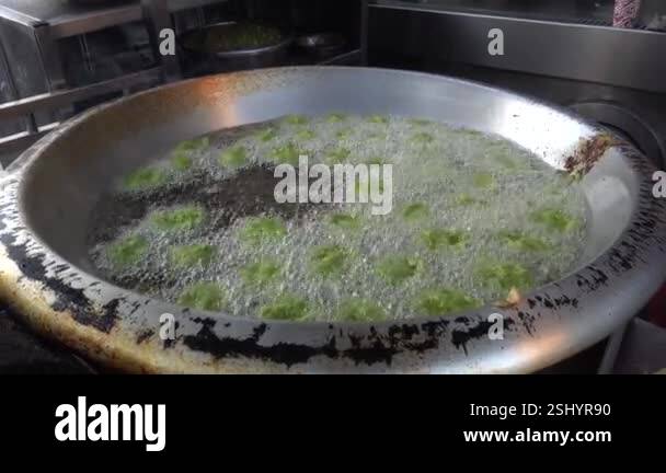 Cairo Egypt Falafel cooking in oil in a large vat at a street kitchen ...