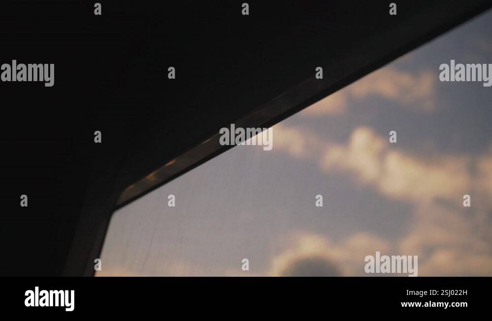 sunrays shining on the window of a boat. outside it's sunrise to a ...