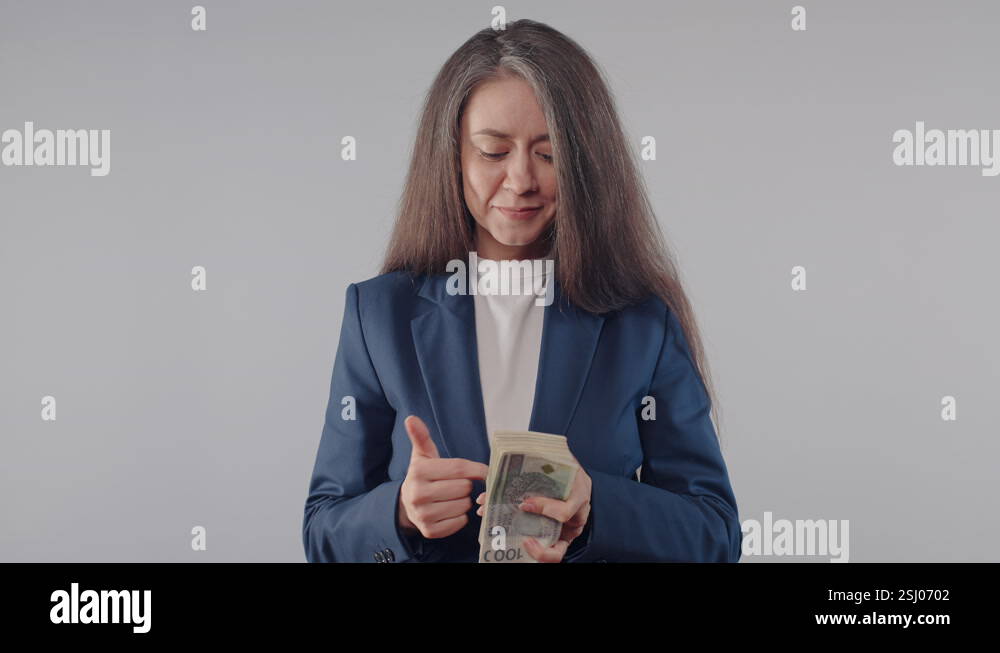 Happy middle aged business woman counting paper money banknotes grey ...
