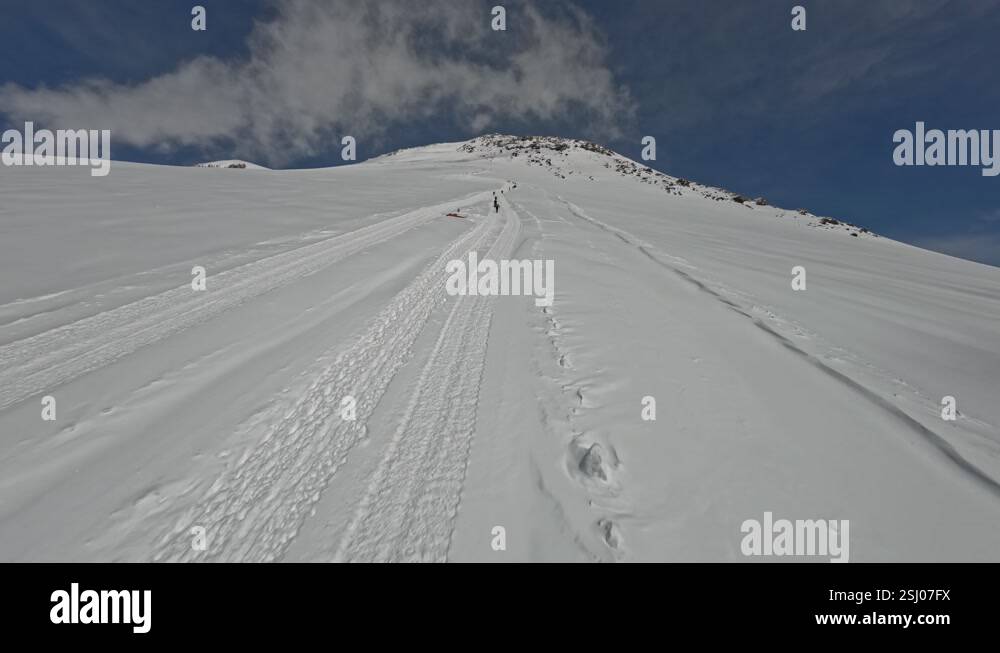 FPV drone raising group people extreme climbers uphill ascending ...