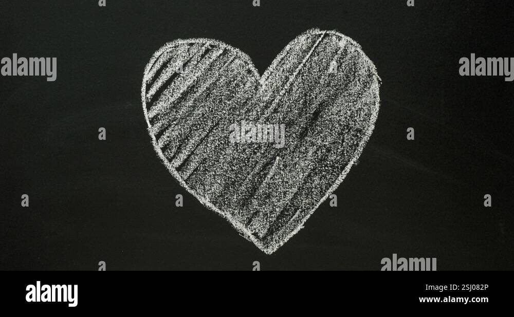Heart drawn with white chalk on a chalkboard. Looped 4K stop motion ...