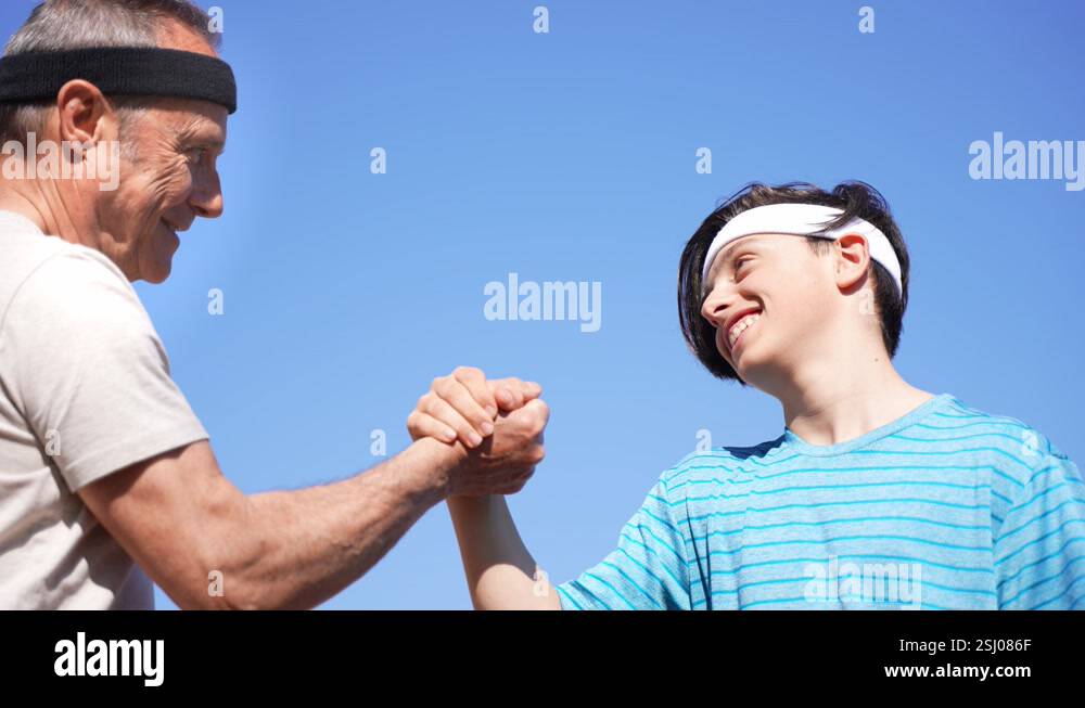 Grandfather and grandson shaking hands after a padel match Stock Video ...