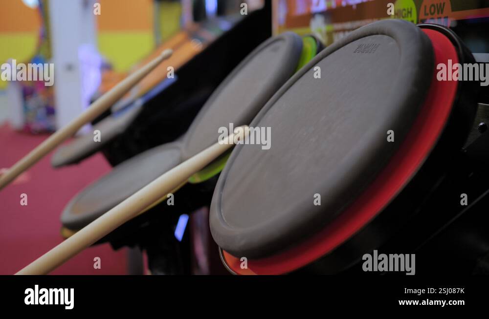 Woman gamer playing retro rhythm drum kits set arcade machine: close up ...