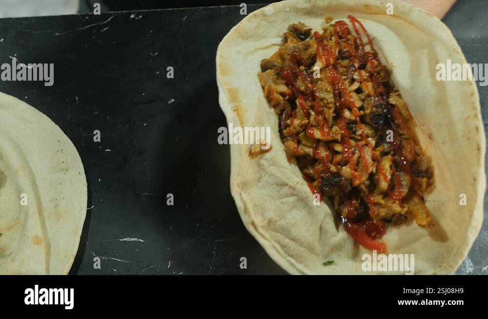 Top view fast food chef holding a bread pita with a bunch of vegetables ...