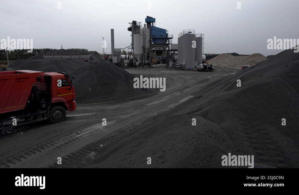 Gravel heaps crushing towers and tipper trucks at quarry Stock Video ...